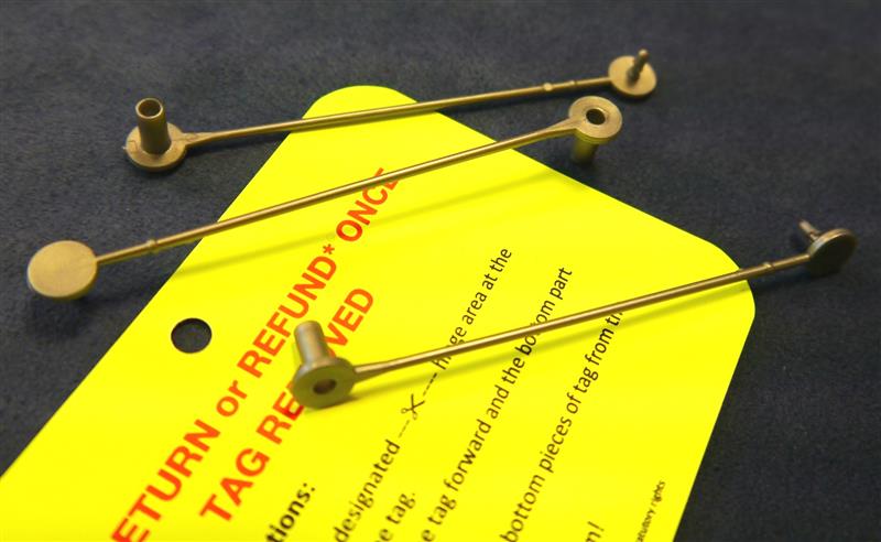 A fastening to secure a ticket or bar code label to an item.